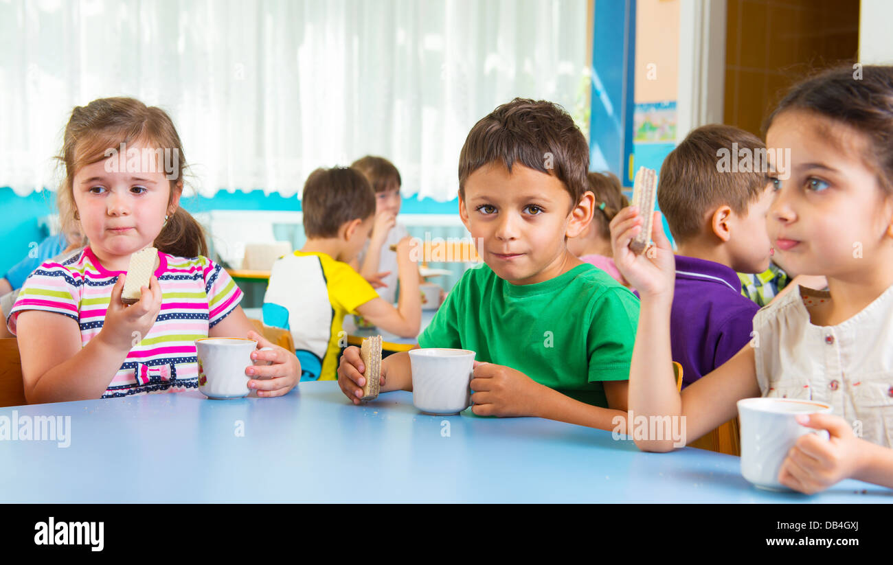Cute little children drinking milk at daycare Stock Photo - Alamy