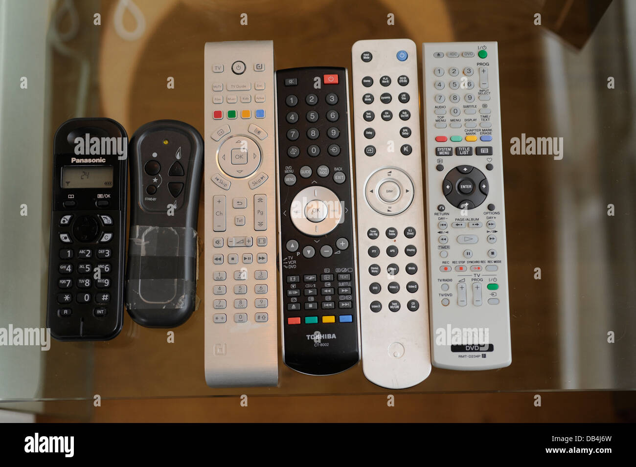Remote controls for TV/ Sky/ DVD/ etc in a home Stock Photo - Alamy