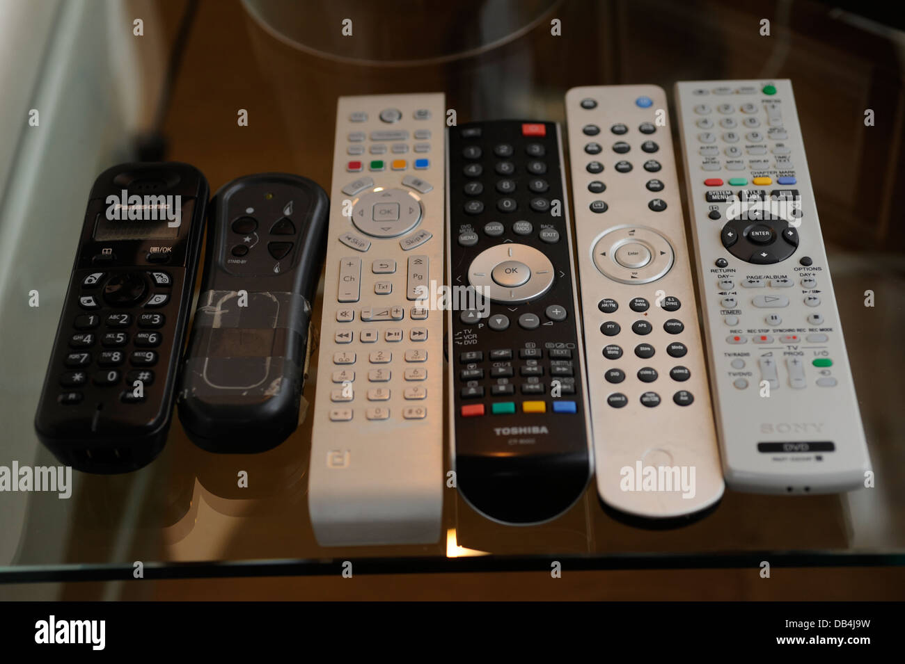 Remote controls for TV/ Sky/ DVD/ etc in a home Stock Photo - Alamy