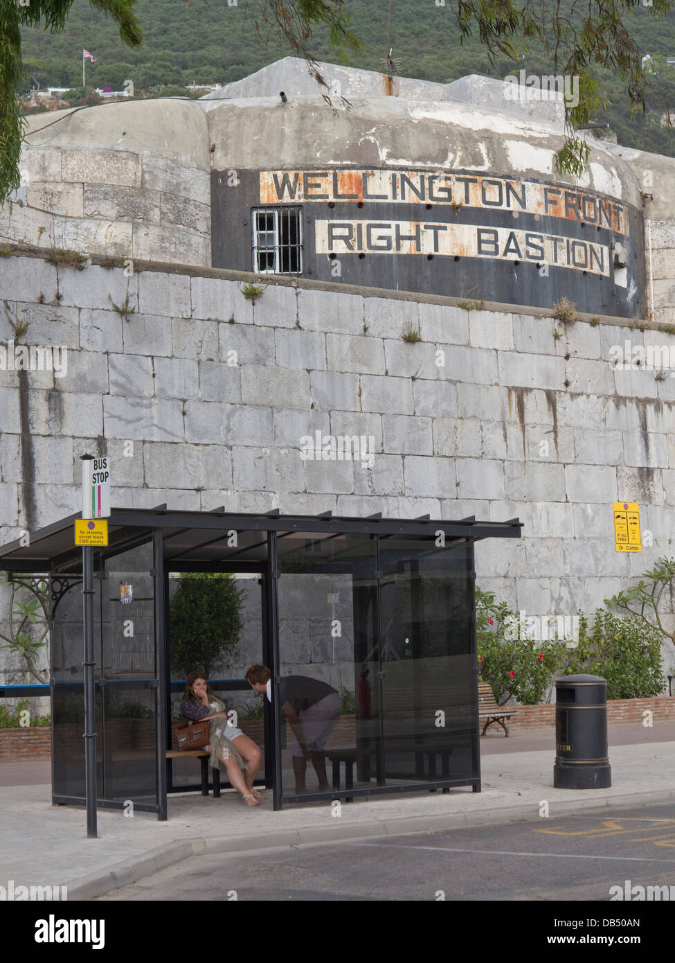 People wait at bust stop by he Wellington Bastion in Gibraltar Stock ...