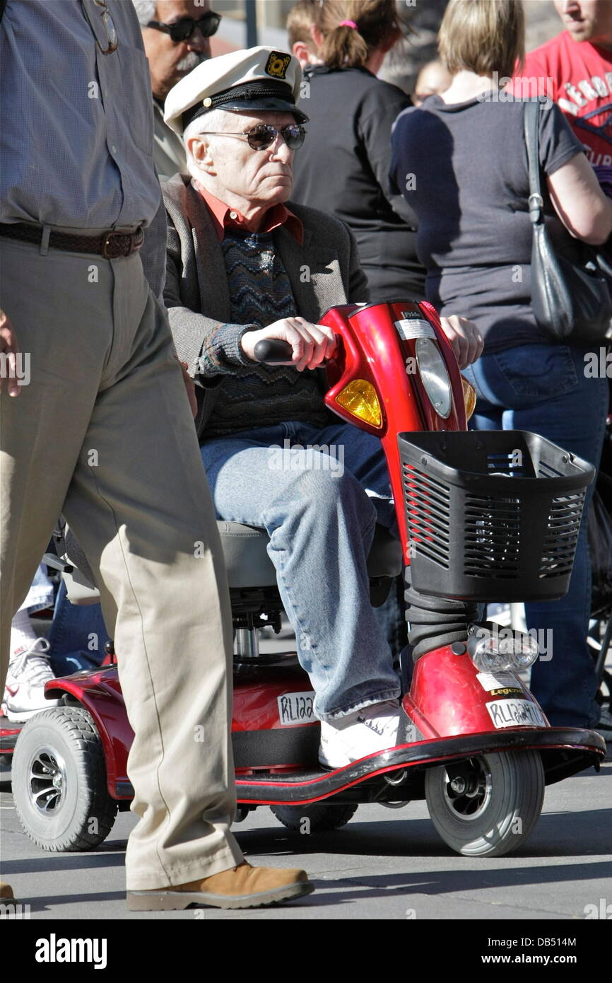 Hugh Hefner riding a mobility scooter whilst enjoying a day out at ...