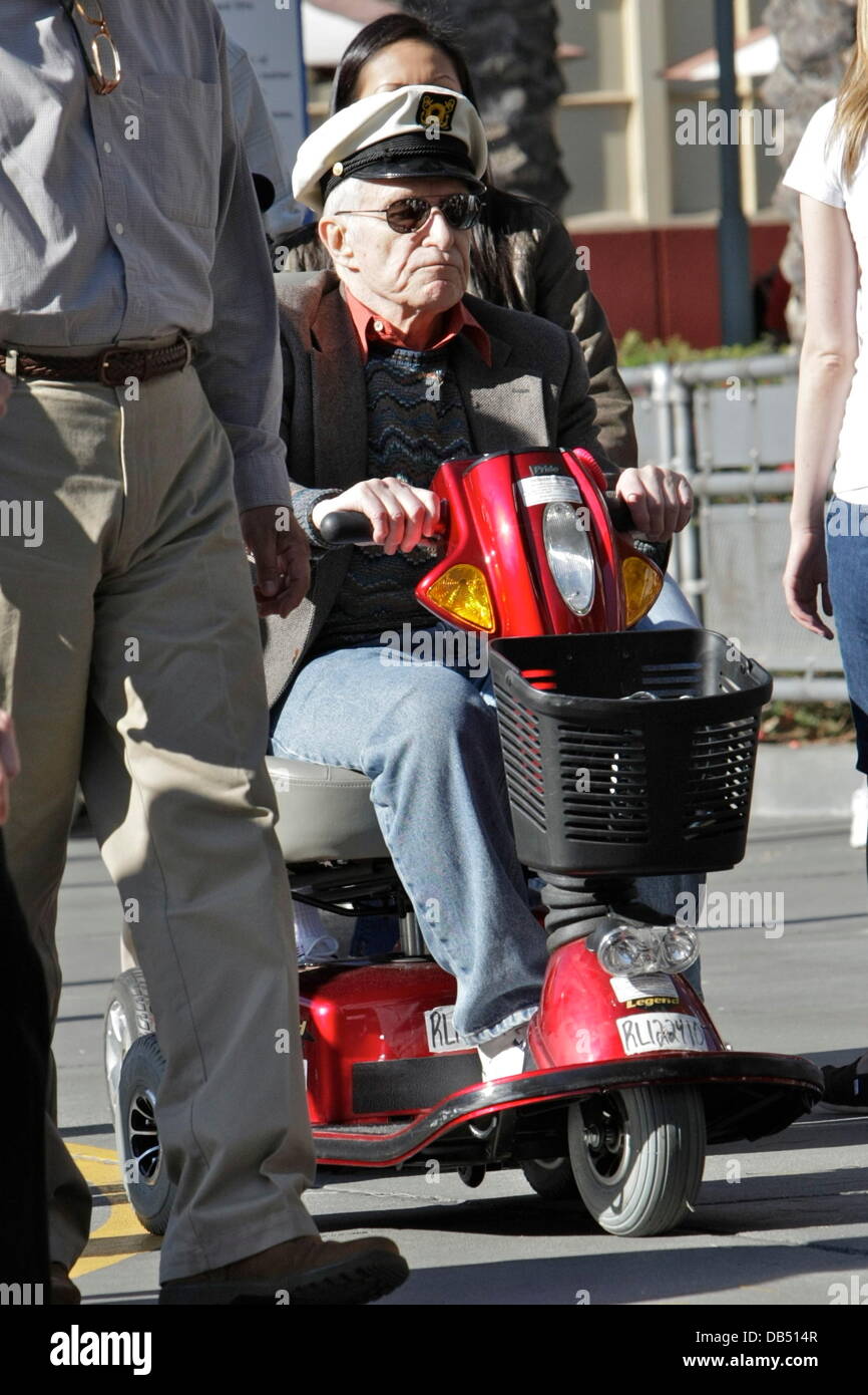 Hugh Hefner riding a mobility scooter whilst enjoying a day out at ...