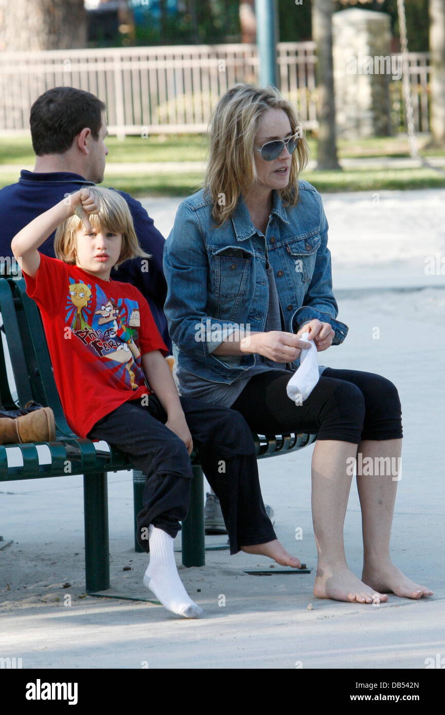 Sharon Stone Helps to put her son Quinn Stone's socks back on at a park ...