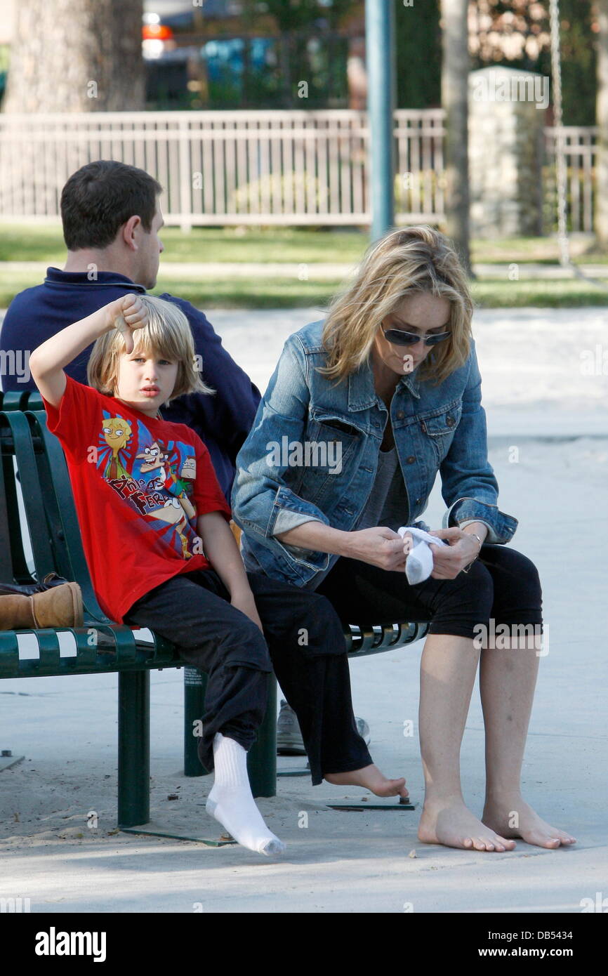 Sharon Stone Helps to put her son Quinn Stone's socks back on at a park ...