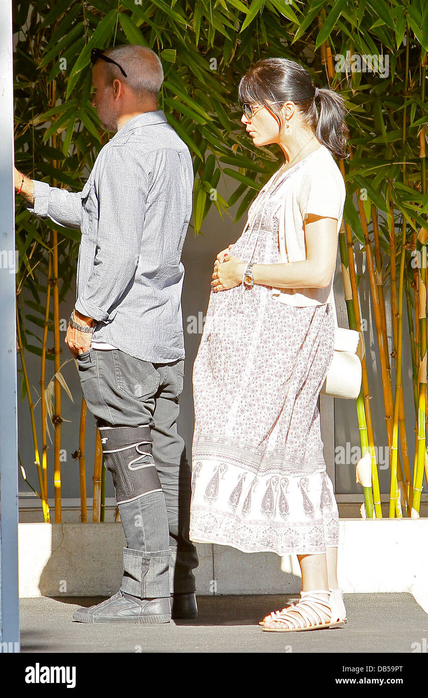 Heavily pregnant Selma Blair in a floral-print dress and sandals with ...