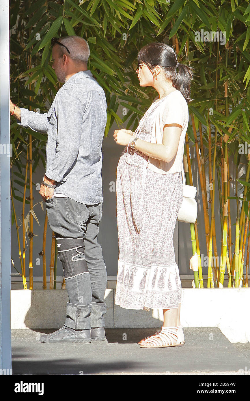 Heavily pregnant Selma Blair in a floral-print dress and sandals with ...