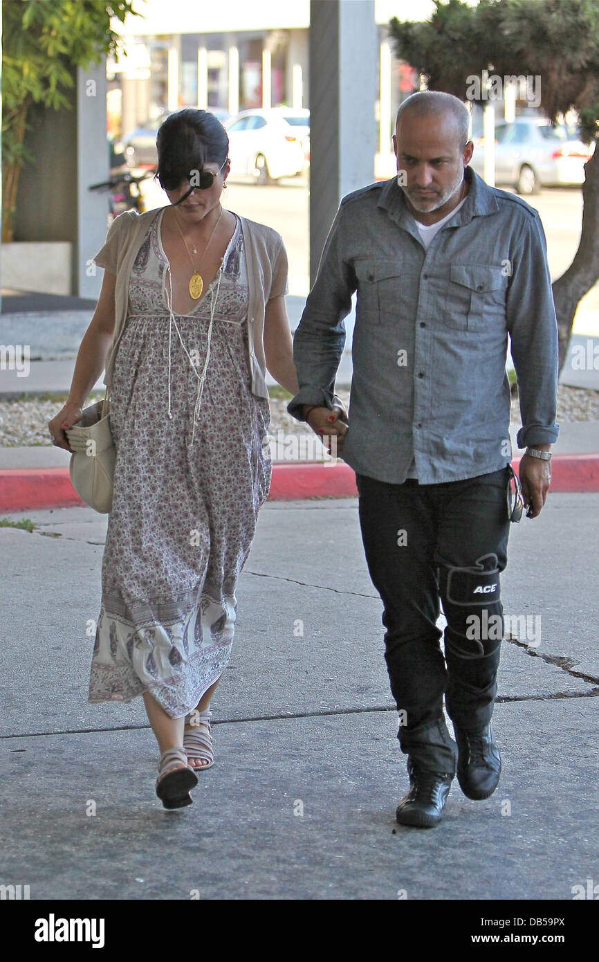 Heavily pregnant Selma Blair in a floral-print dress and sandals with ...