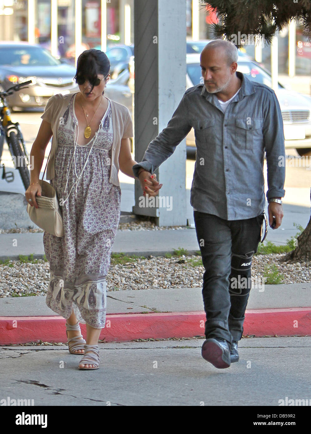 Heavily pregnant Selma Blair in a floral-print dress and sandals with ...