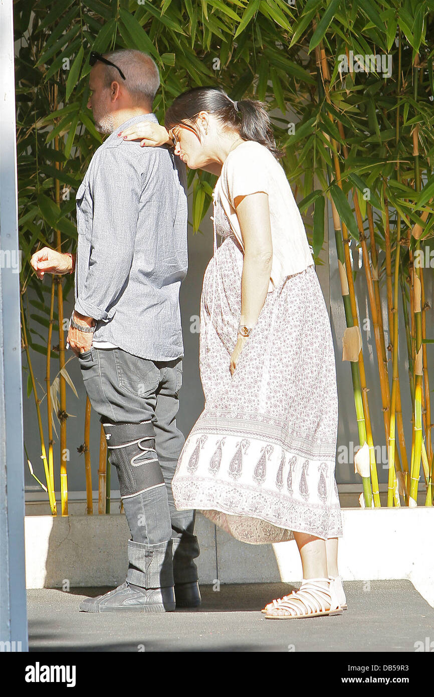 Heavily pregnant Selma Blair in a floral-print dress and sandals with ...