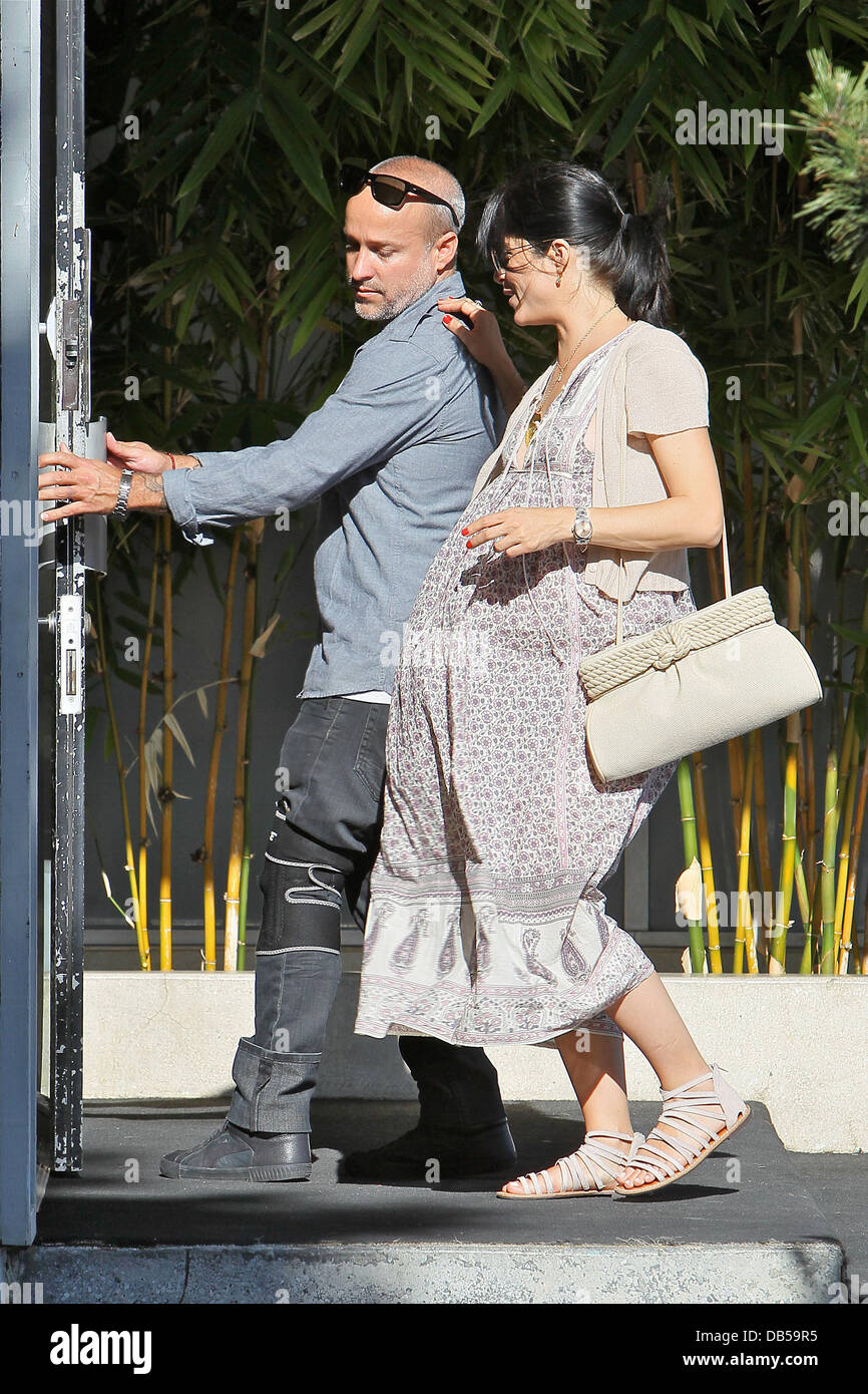 Heavily pregnant Selma Blair in a floral-print dress and sandals with ...