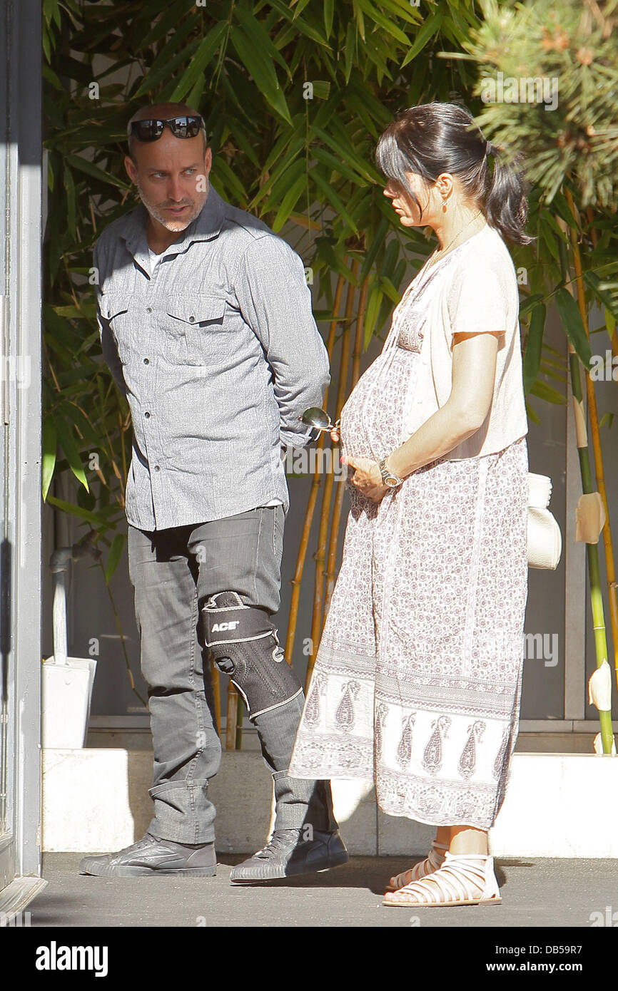 Heavily pregnant Selma Blair in a floral-print dress and sandals with ...