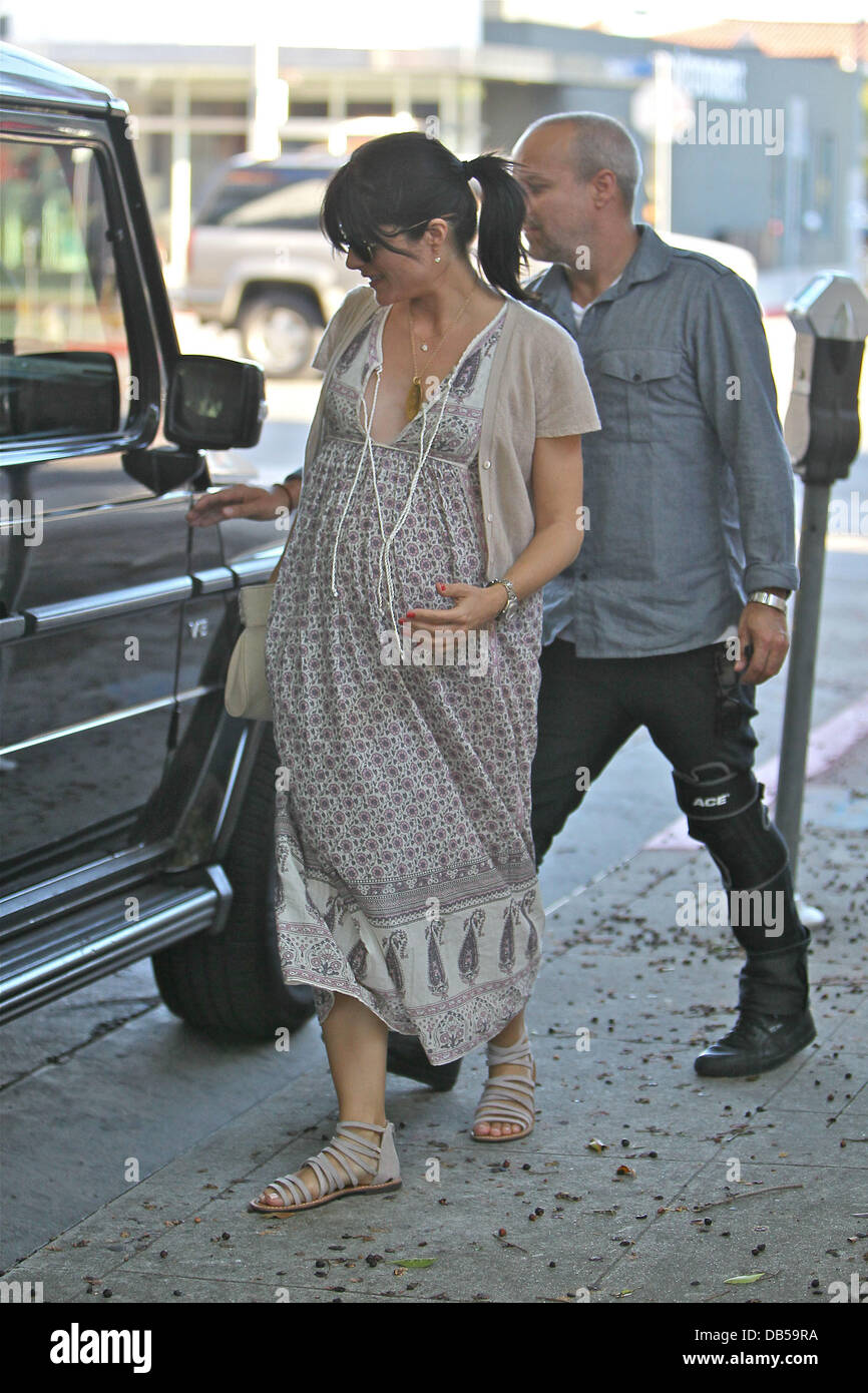 Heavily pregnant Selma Blair in a floral-print dress and sandals with ...