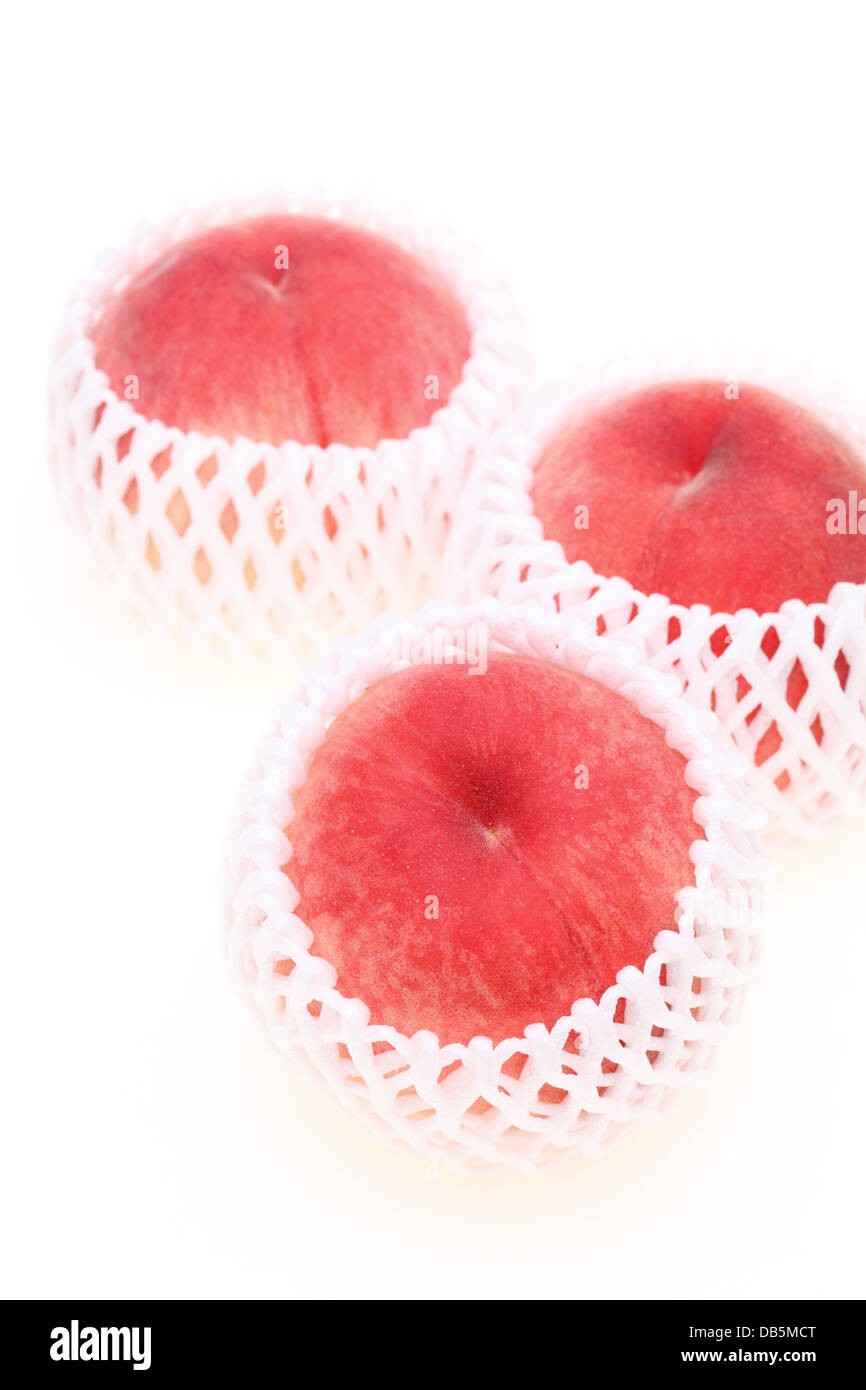 fresh peaches in protection net Stock Photo - Alamy