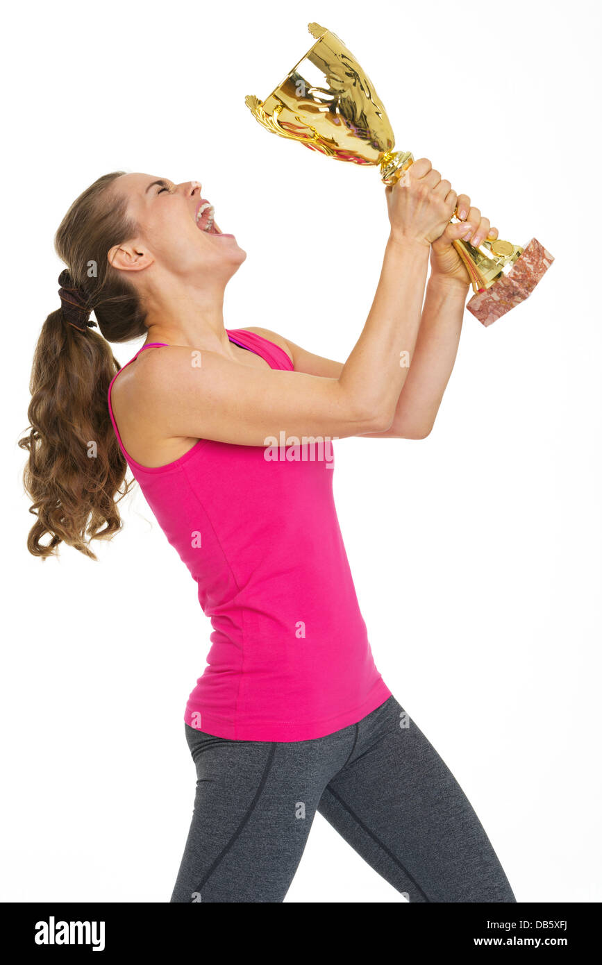 Happy fitness young woman holding gold trophy cup Stock Photo - Alamy