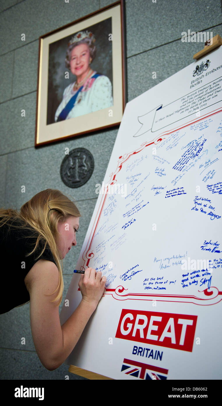 A woman signs on a large greeting card in the British Embassy in Berlin ...