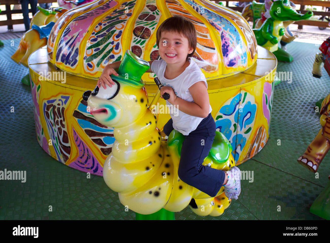 Child enjoying carousel Stock Photo - Alamy