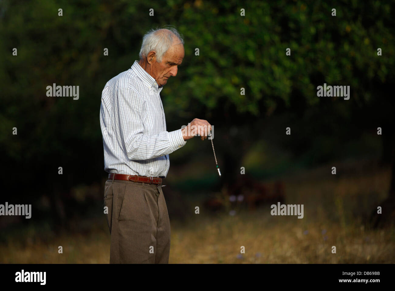 A water diviner uses a pendulum to find water in Prado del Rey, Cadiz ...