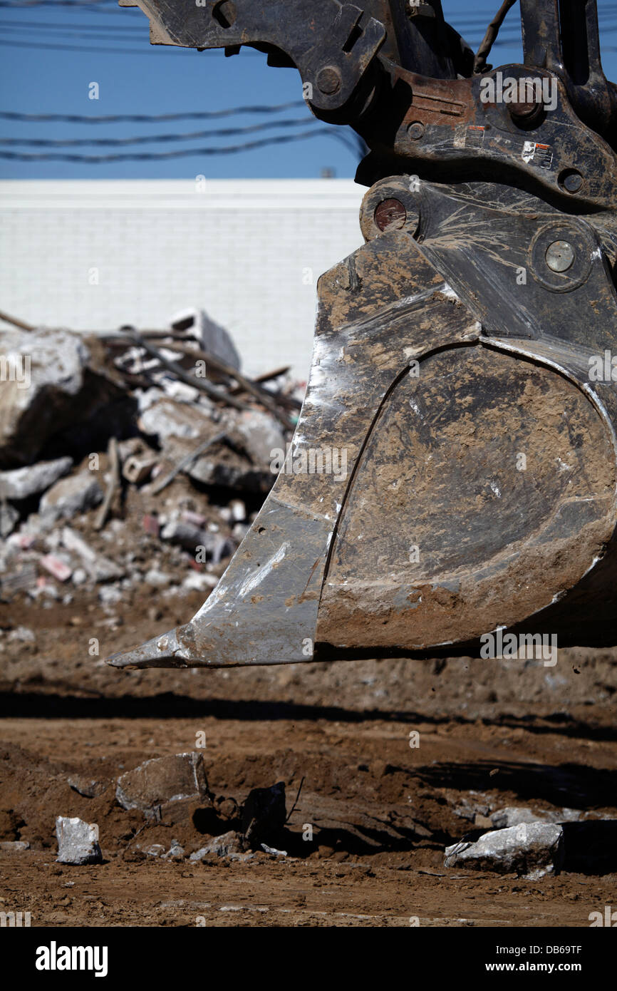 Excavator bucket near debris pile Stock Photo - Alamy