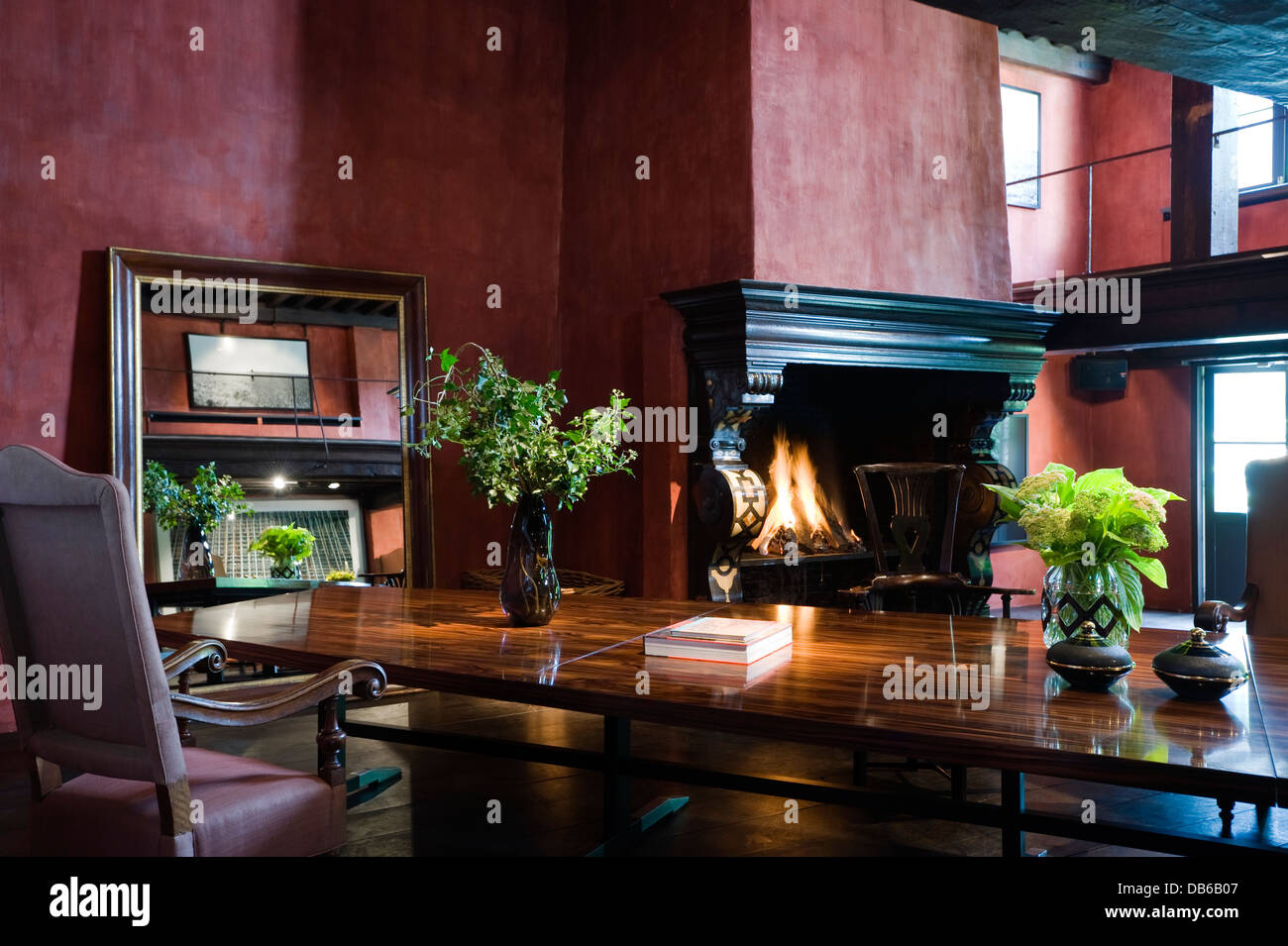 Polished wooden table with dark wood platform in Antwerp apartment of ...