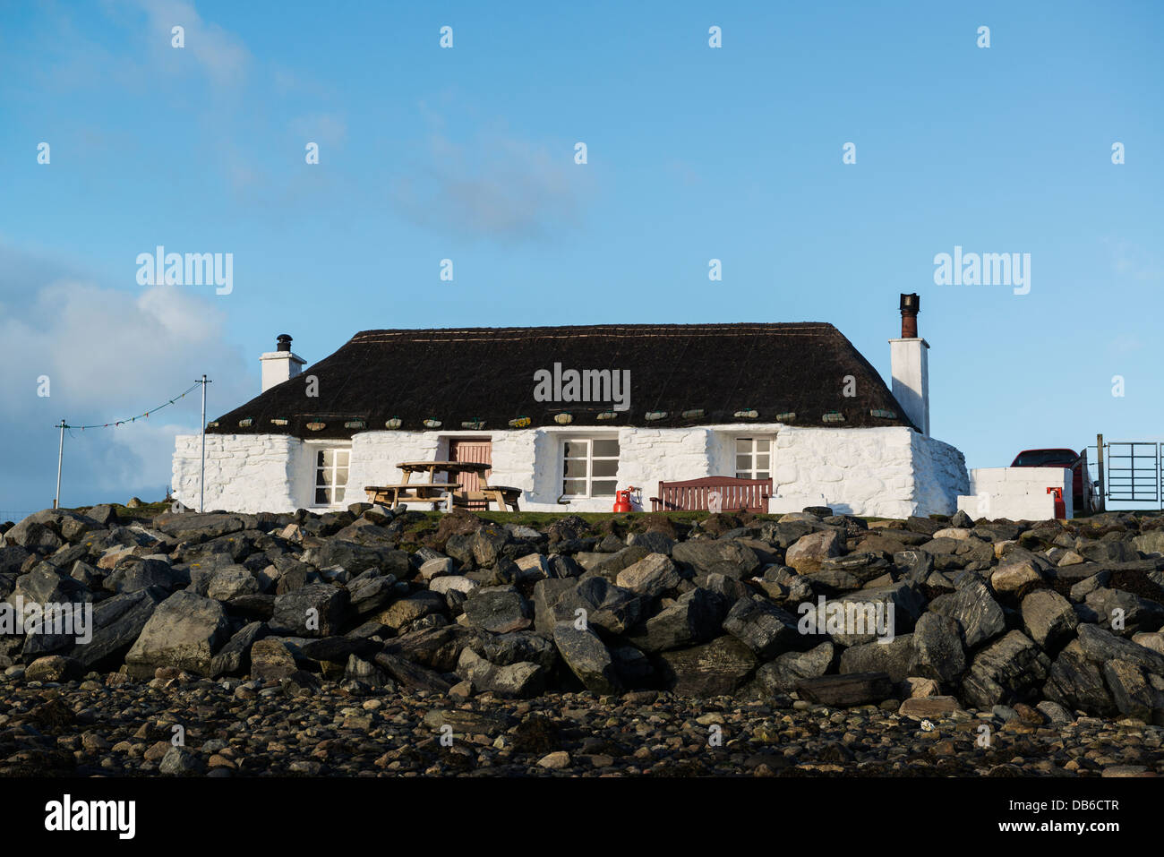Thatched roof traditional blackhouse now used as youth hostel, Berneray ...