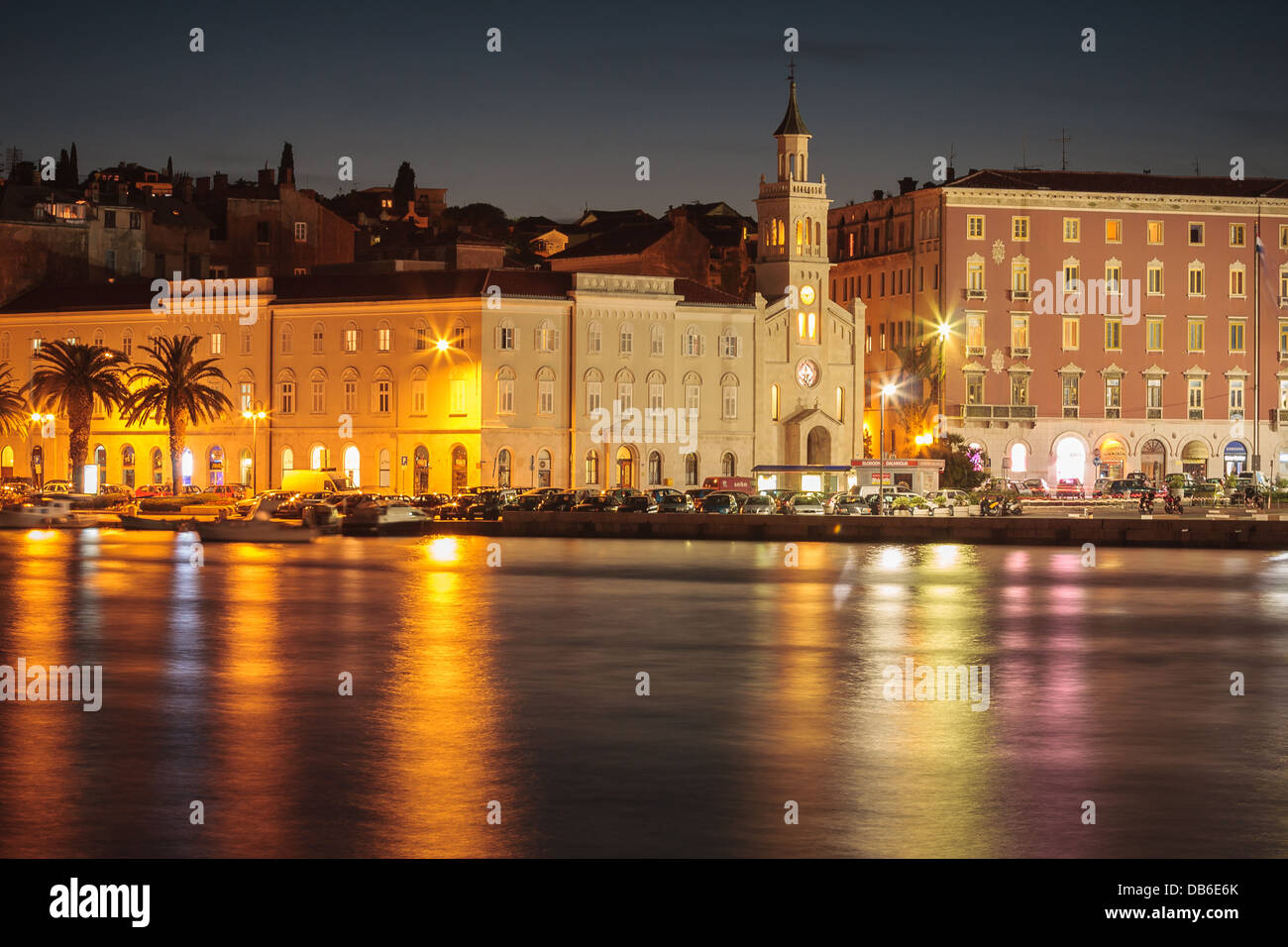 Reflections in the water of Split Riva at night, showing the Franciscan ...