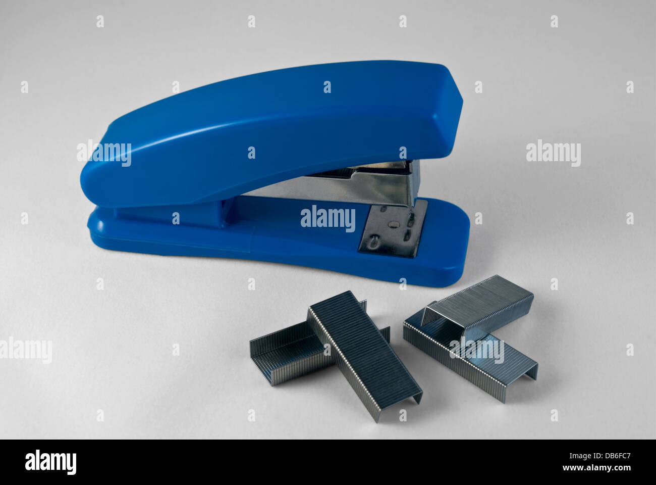 Blue stapler and staples on a light background Stock Photo - Alamy