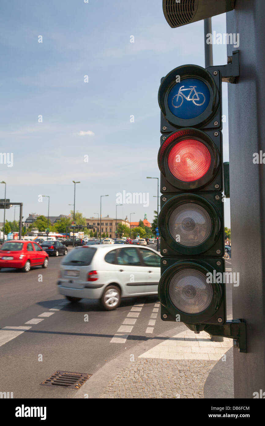 Traffic light for cyclists, bicycle light turns red and a car cross the ...