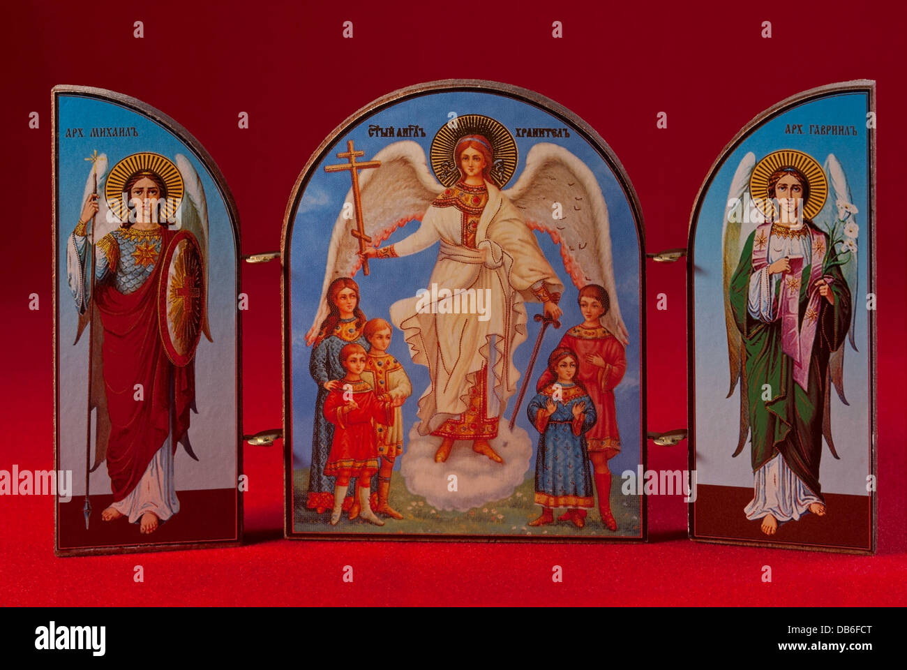 Wooden icon with the image of the Holy Trinity isolated on a red ...