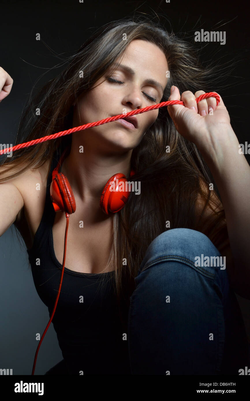 beautiful young woman tied with the red rope Stock Photo - Alamy