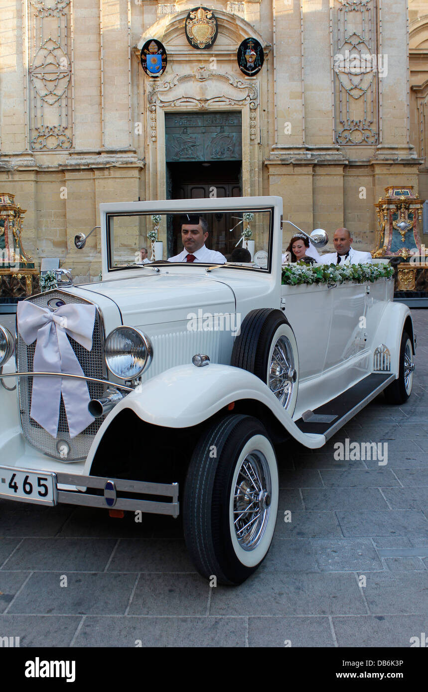 A limo driver with newlyweds in a 1930 Ford Model DeLuxe limousine ...