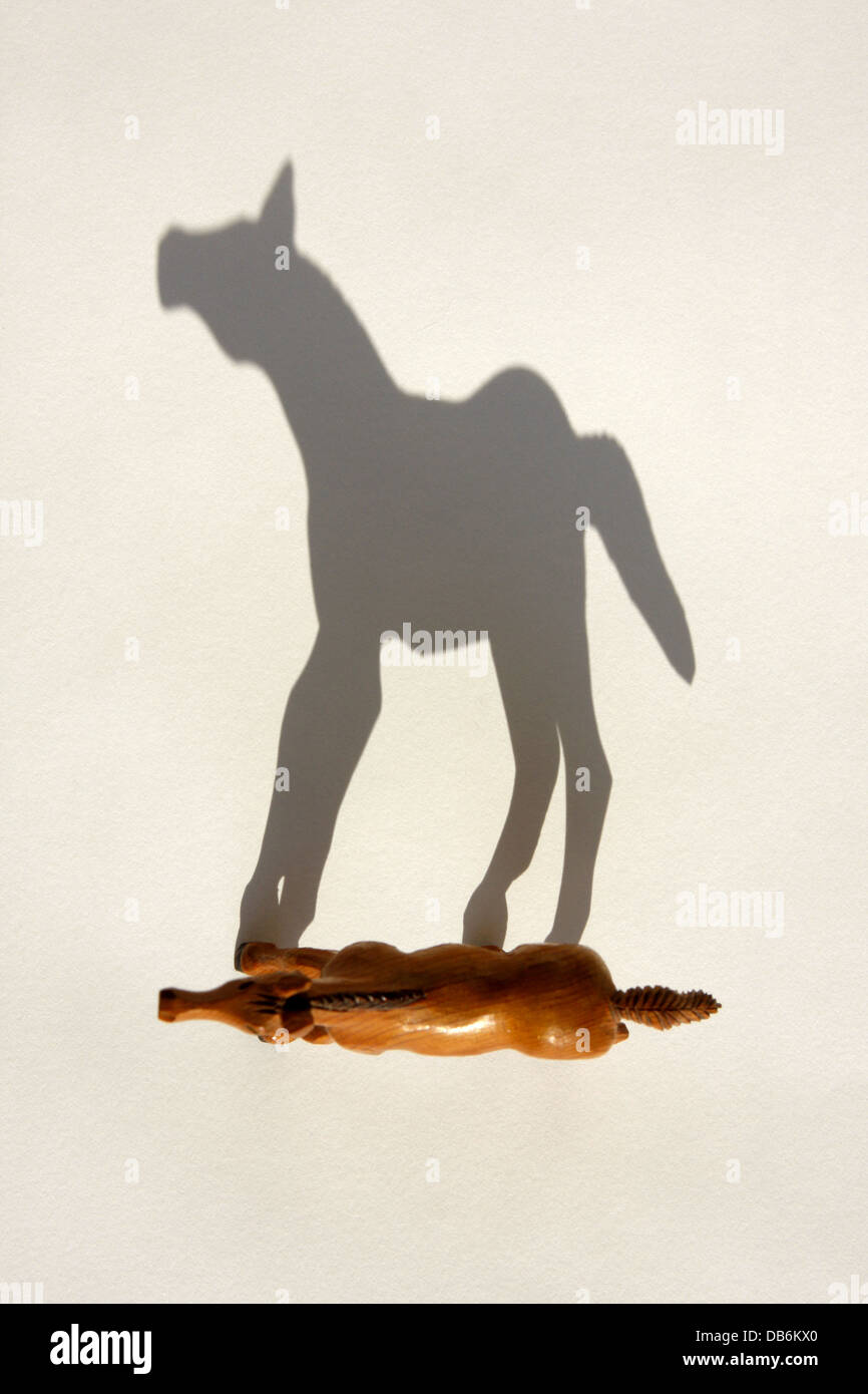 Shadow of a wooden carving of a horse. Focus on shadow Stock Photo - Alamy