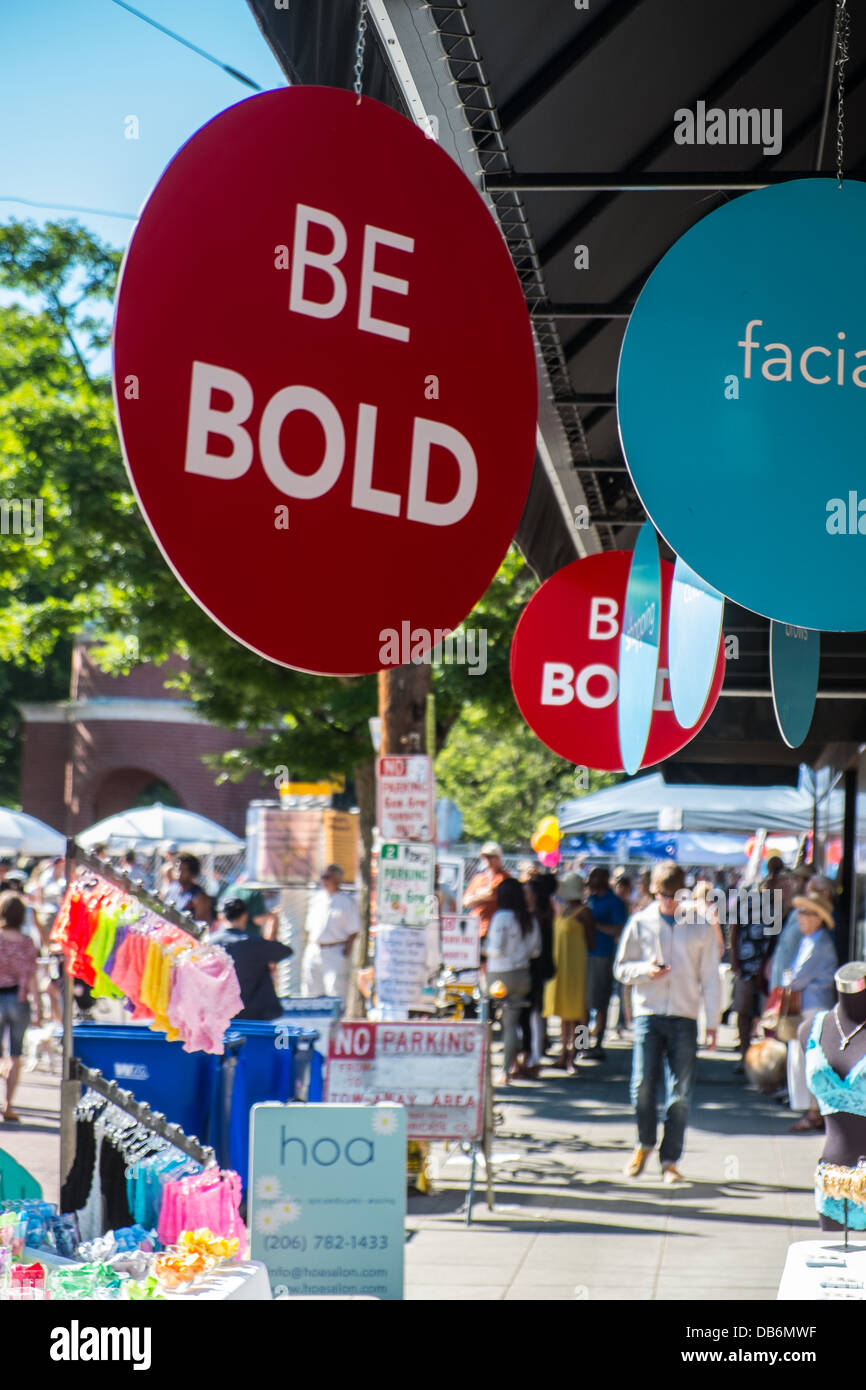 A hanging round store sign saying 'Be Bold' Stock Photo - Alamy