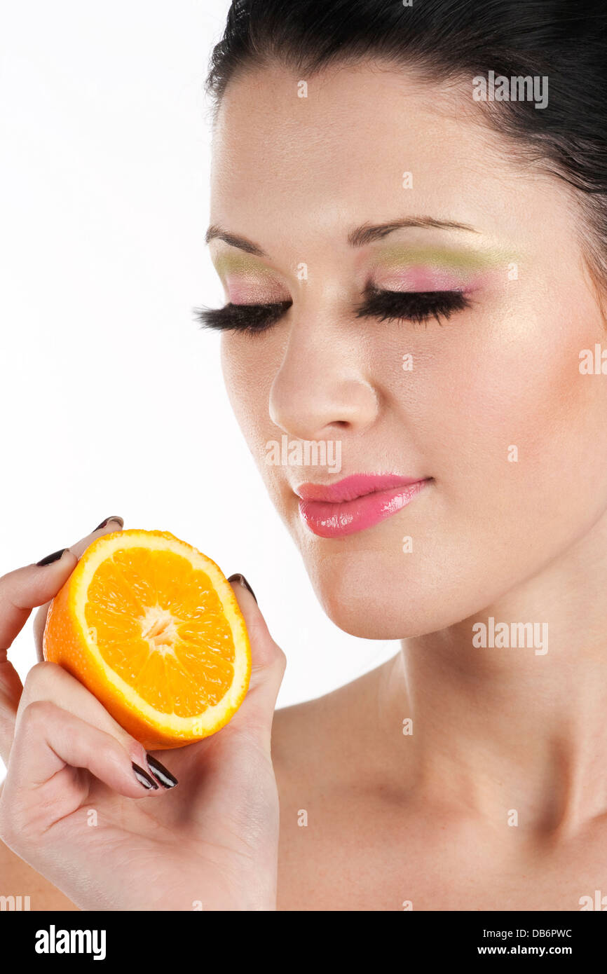 Beautiful model holding orange Stock Photo - Alamy
