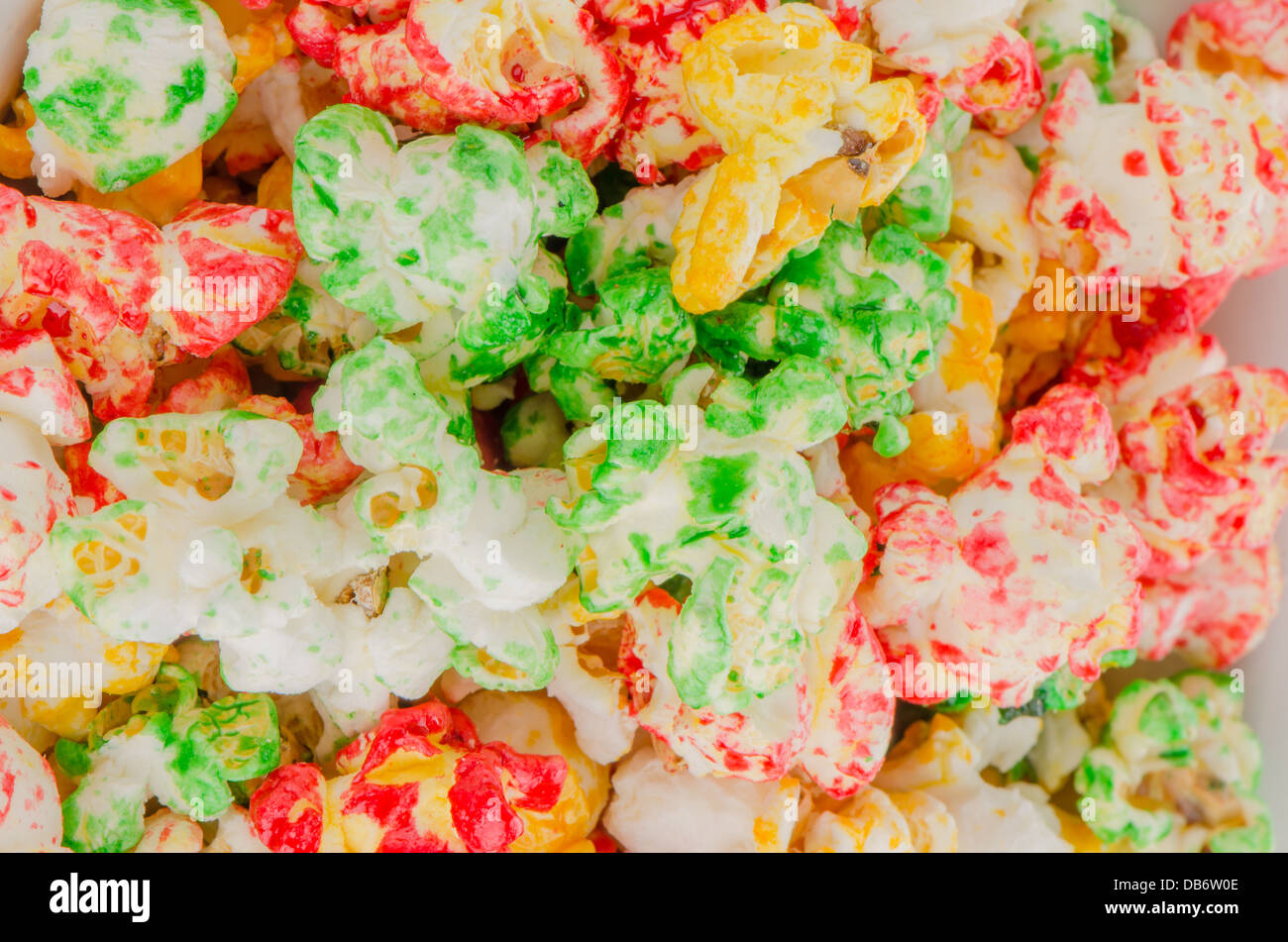 Popped color kernels of pop corn snack background Stock Photo - Alamy