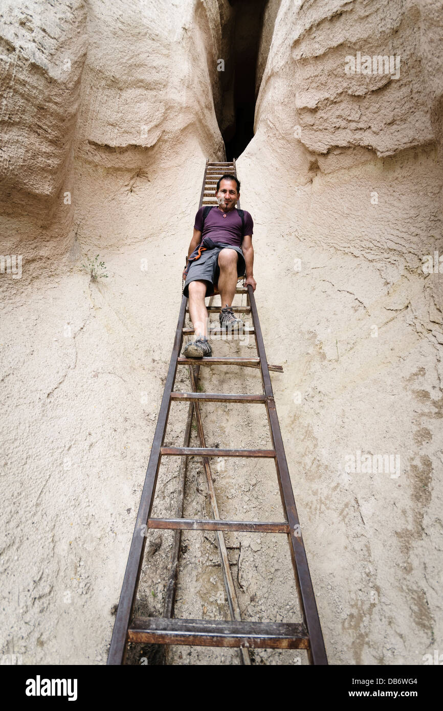Cappadocia, Turkey. Italian tourist descending ladder in rocks. (MR ...