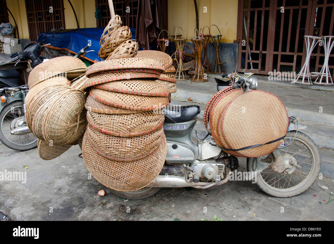 Vietnam, Da Nang, Hoi An. Traditional bamboo baskets on scooter. A ...
