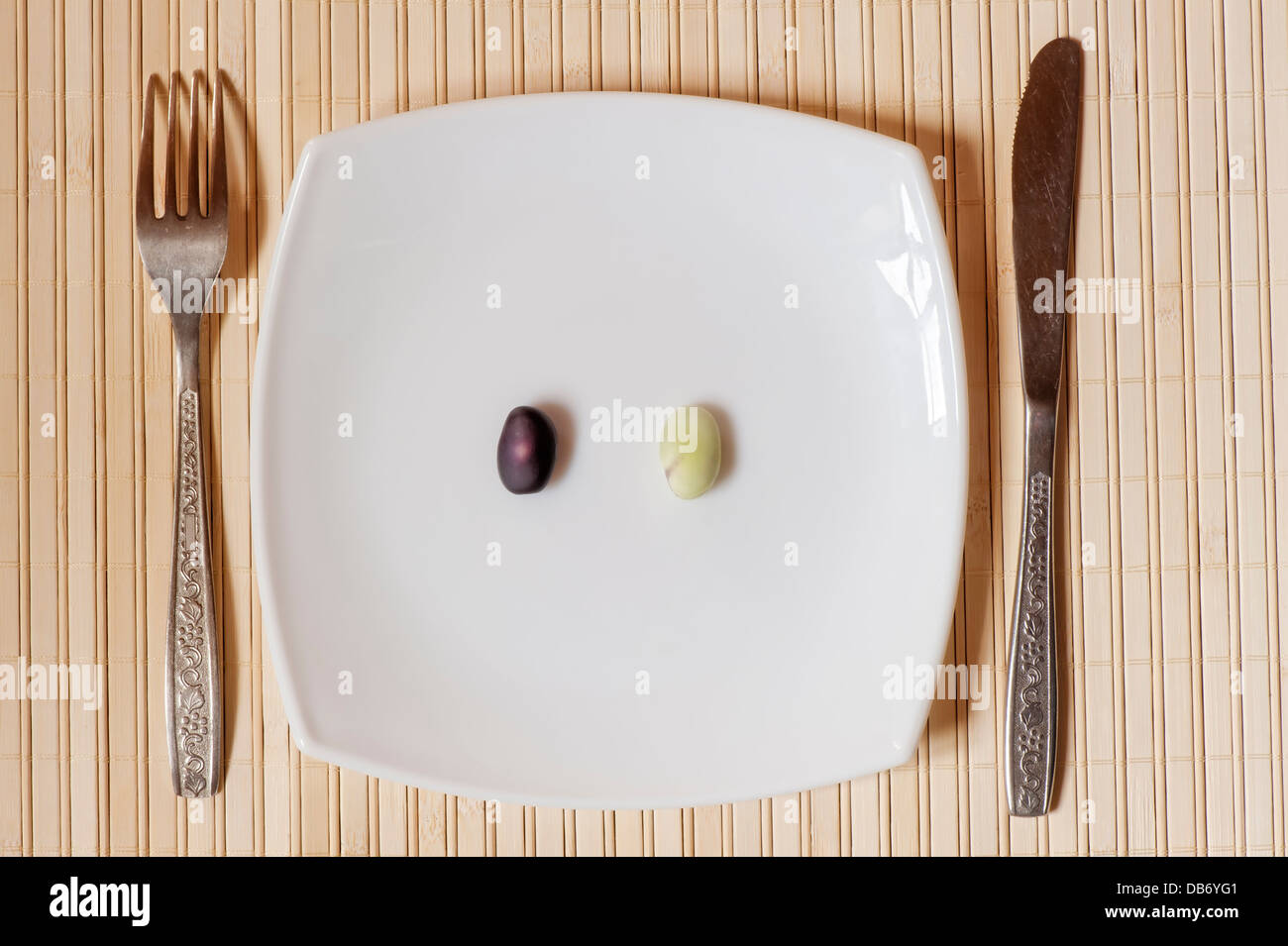 Two pods to choose from on a white square plate Stock Photo - Alamy