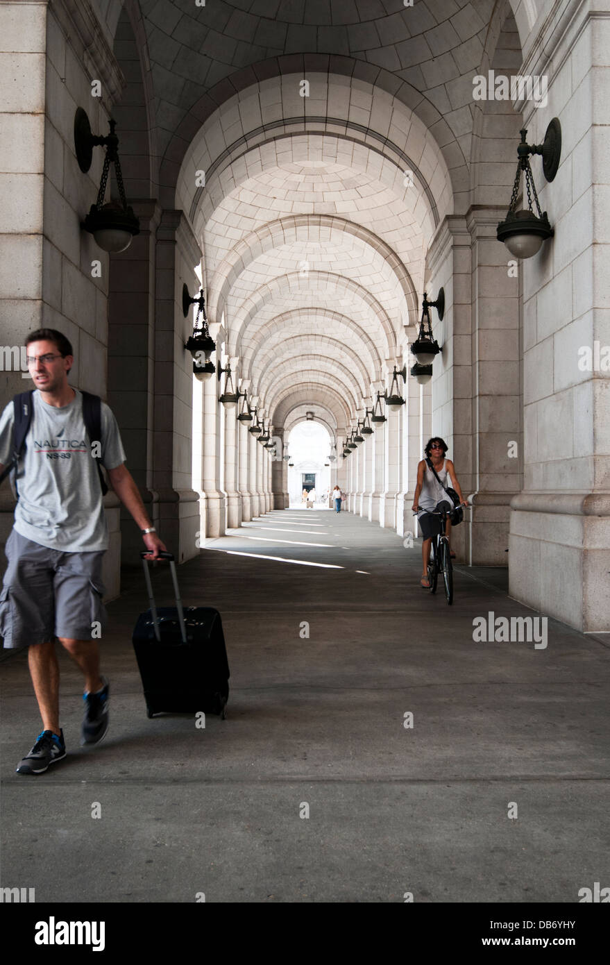 Travelers walking through the arched walkway outside of Union Station ...