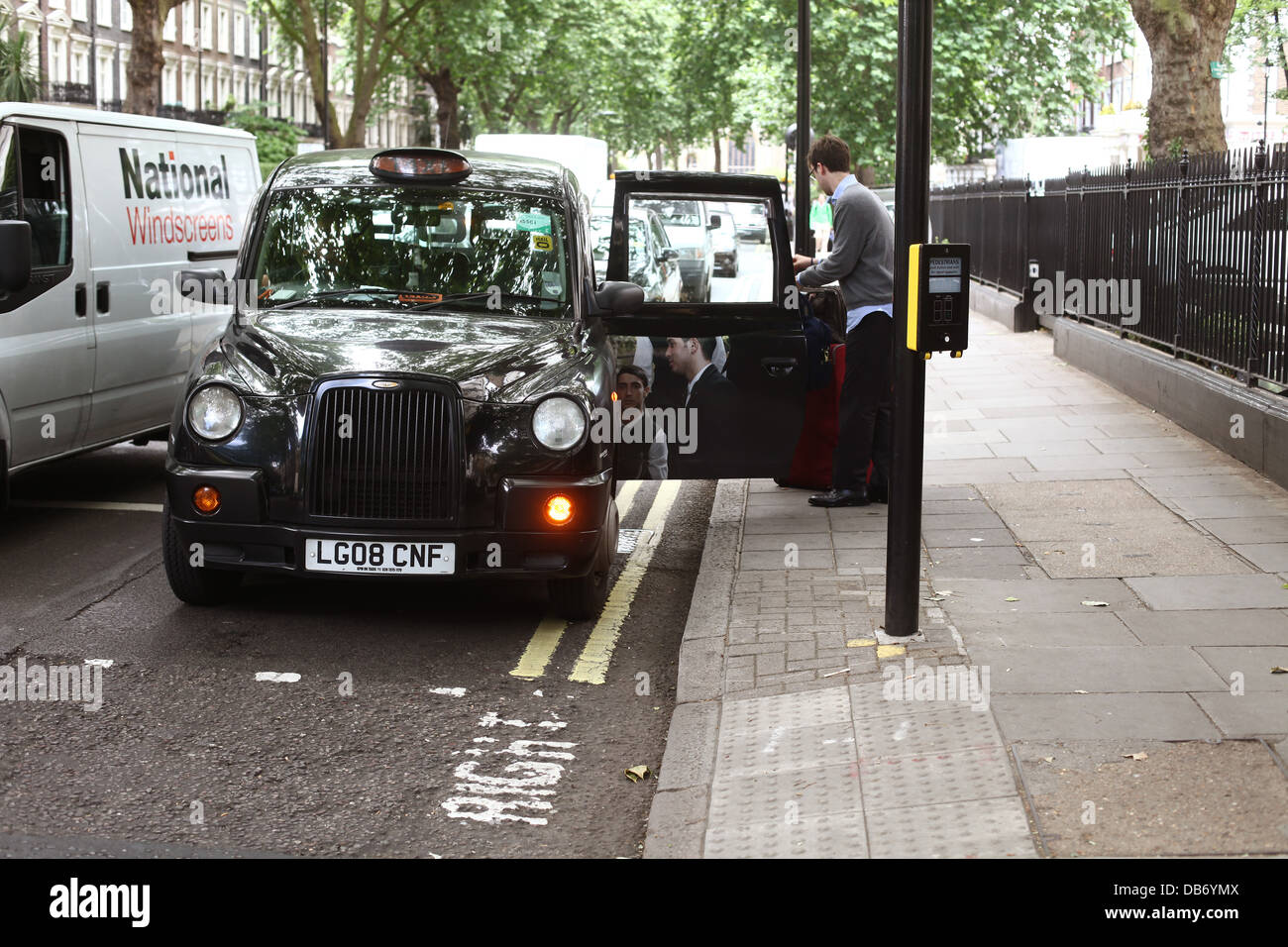 Young man boarding a taxi in Central London, July 2013 Stock Photo - Alamy