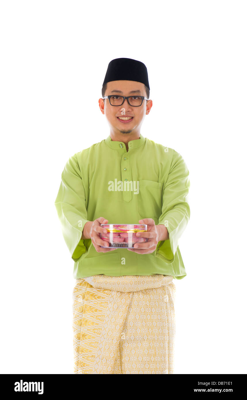 Traditional Malay male with biscuit during hari raya Stock Photo - Alamy