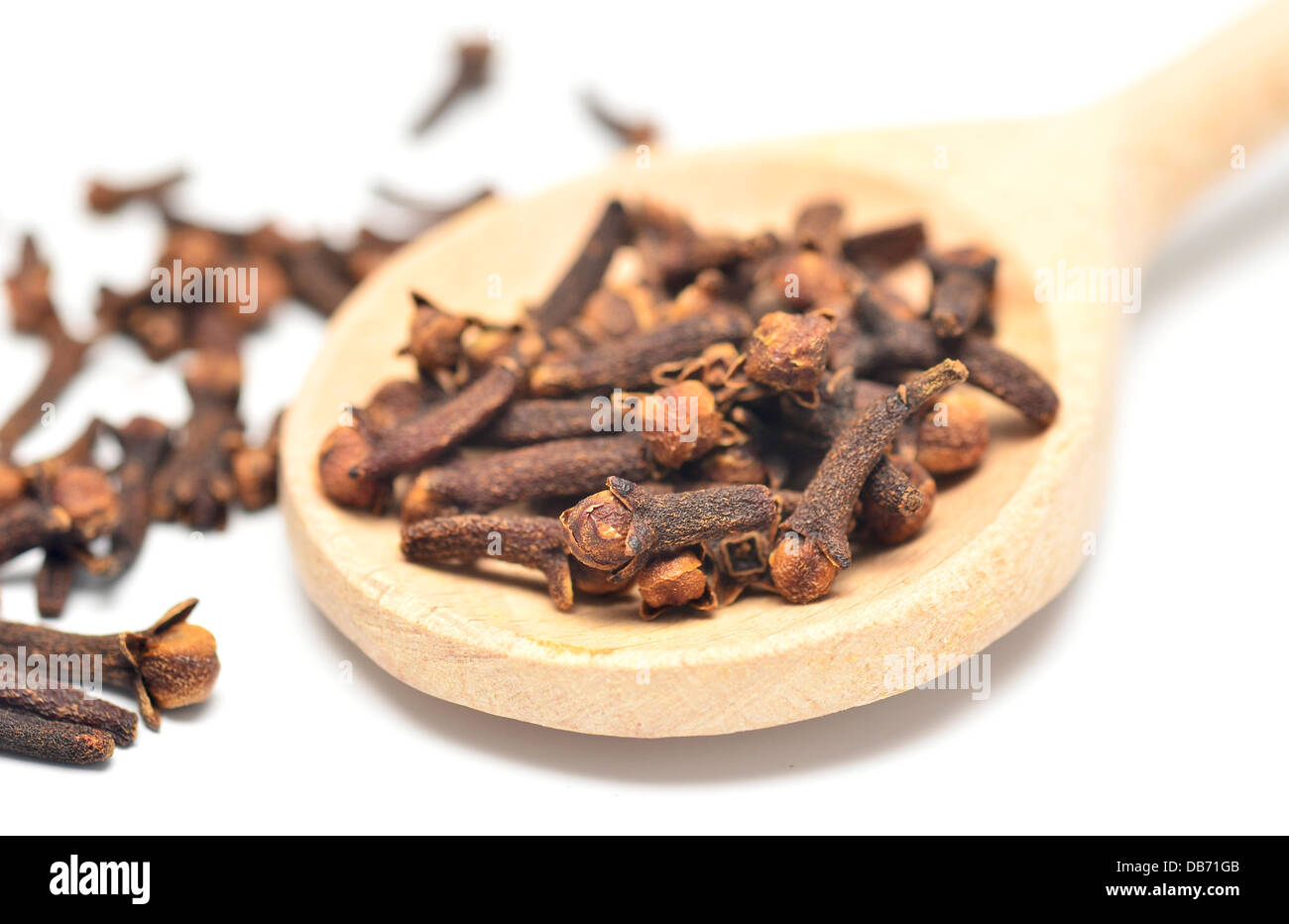cloves in a wooden spoon on white background Stock Photo - Alamy