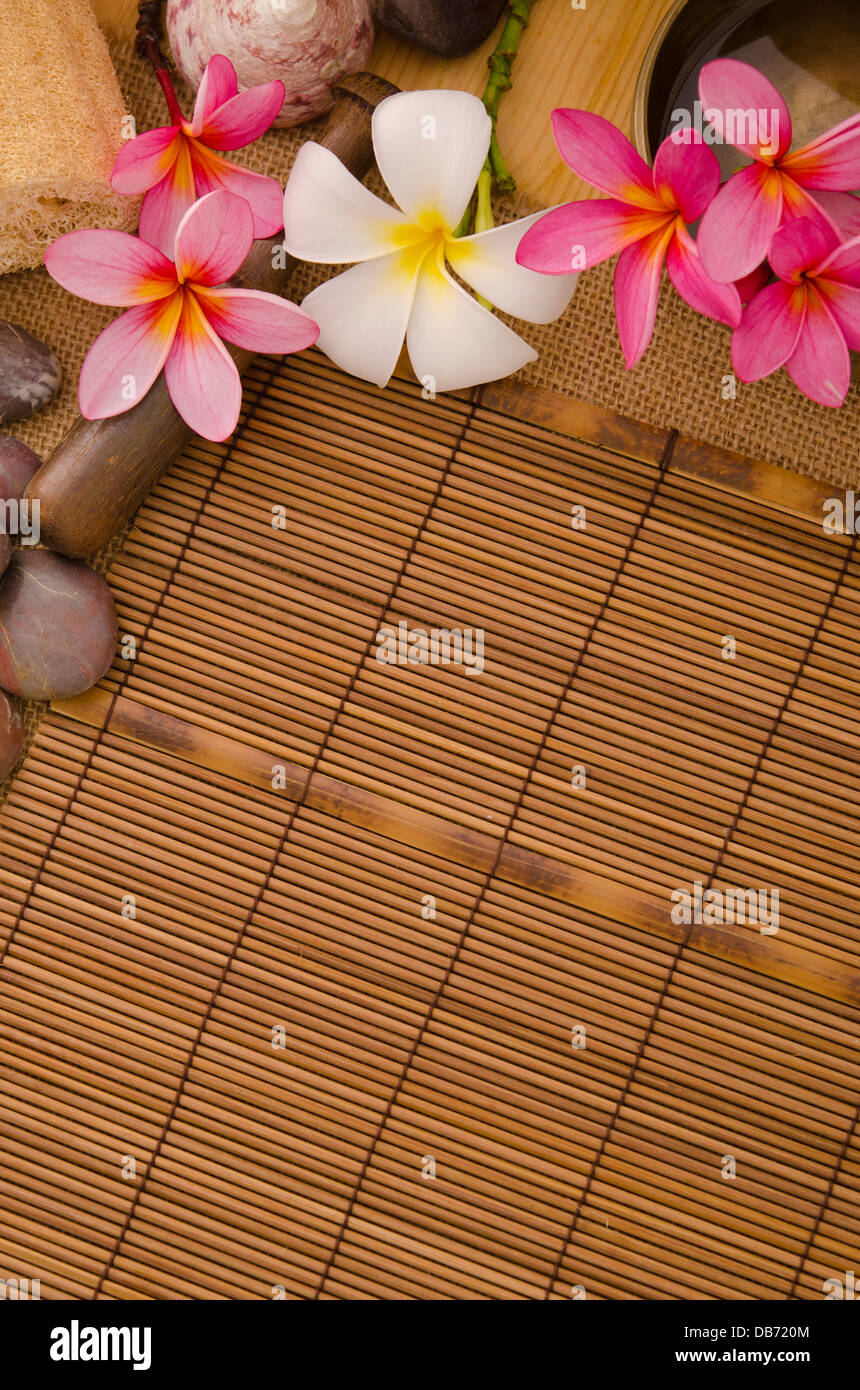 tropical spa setup with traditional frangipani flower and massage items ...