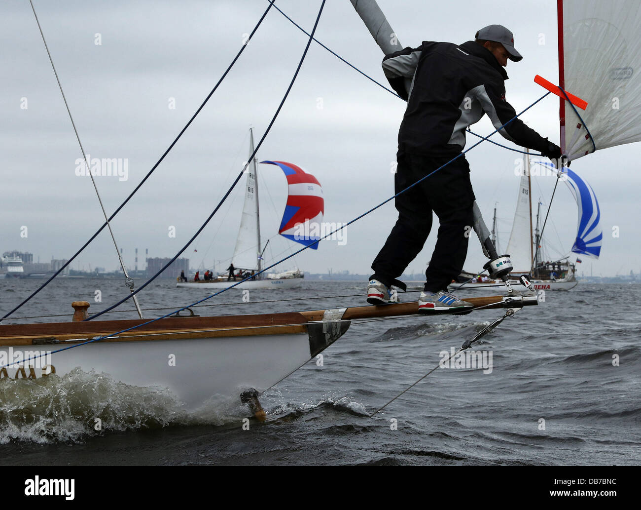 Gulf of Finland. 24th July, 2013. Sailor walks the bow to tie a sail ...