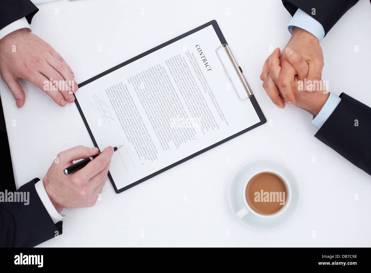Image of businessman hands signing contract with his partner hands near ...