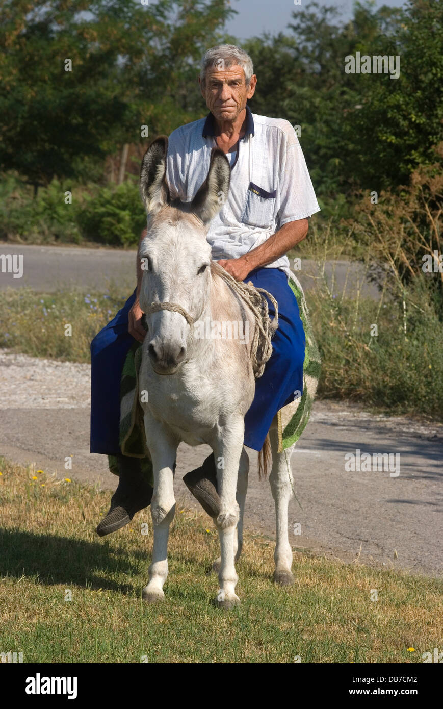 Man rides donkey as his form of transport in rural village at the ...
