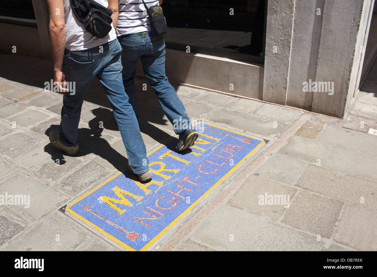 A pavement sign points the way to the Martini Night Club in Venice ...