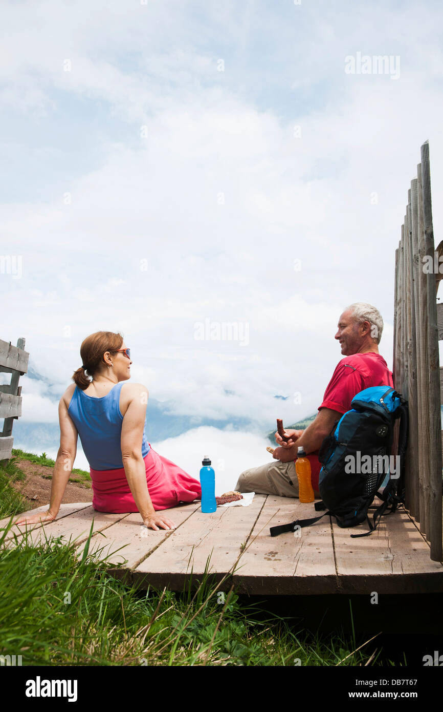 Hiking couple taking a break Stock Photo - Alamy