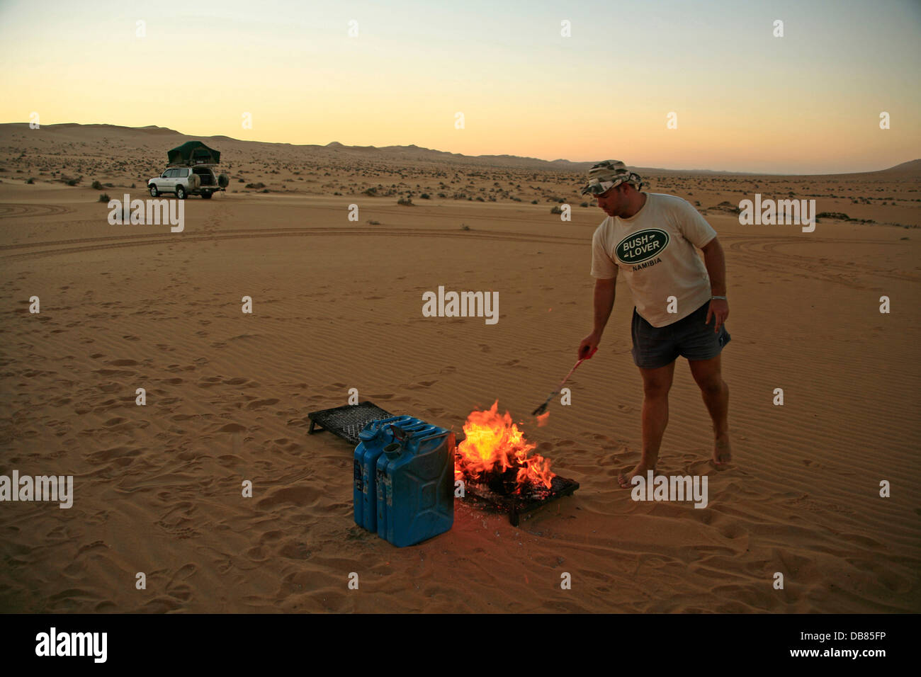 camping and making a fire at sunset in the Namib Desert, Namibia Stock ...