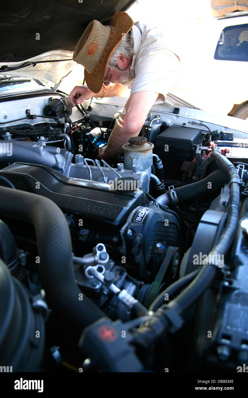 a man fixes the engine of a motor vehicle Stock Photo - Alamy