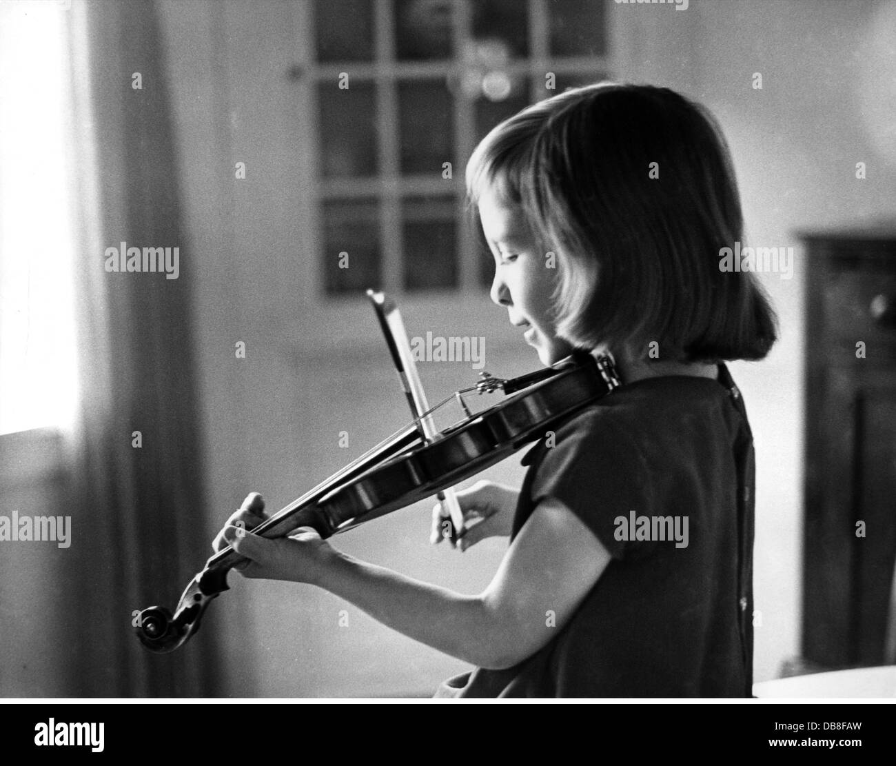 Girl playing instruments Black and White Stock Photos & Images - Alamy